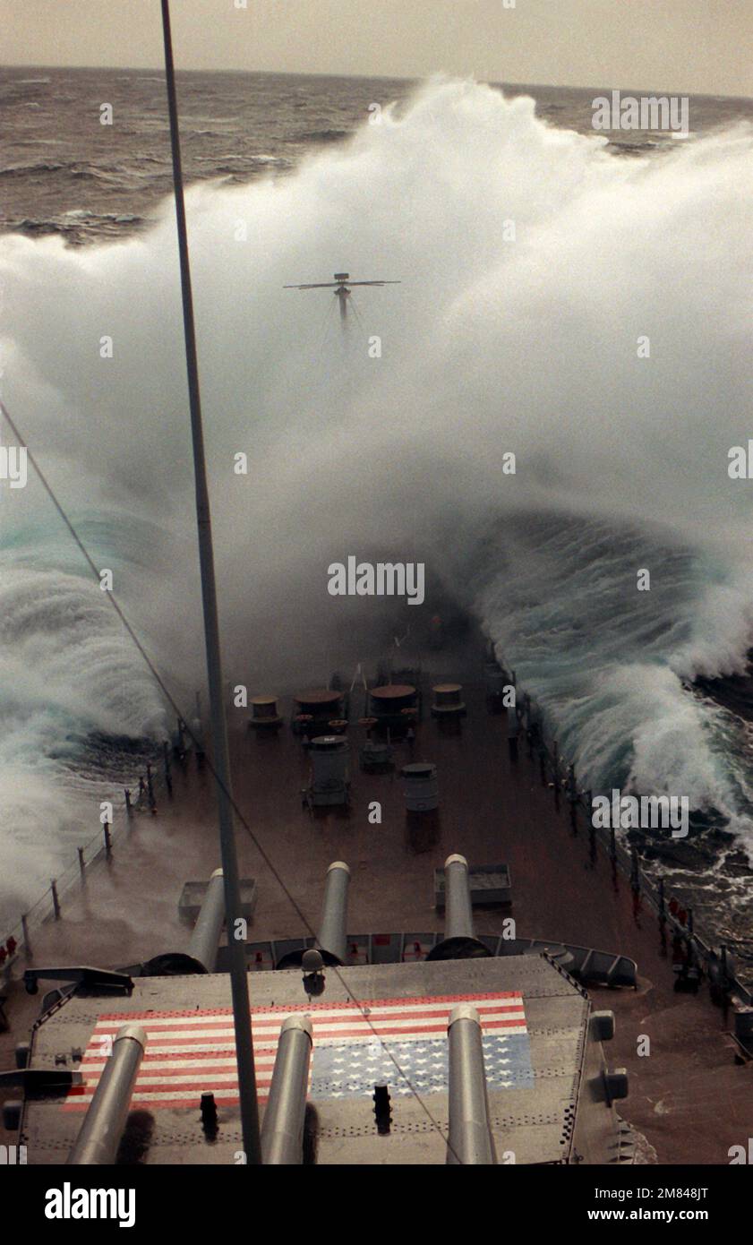 The battleship USS IOWA (BB-61) takes water over the bow while underway ...