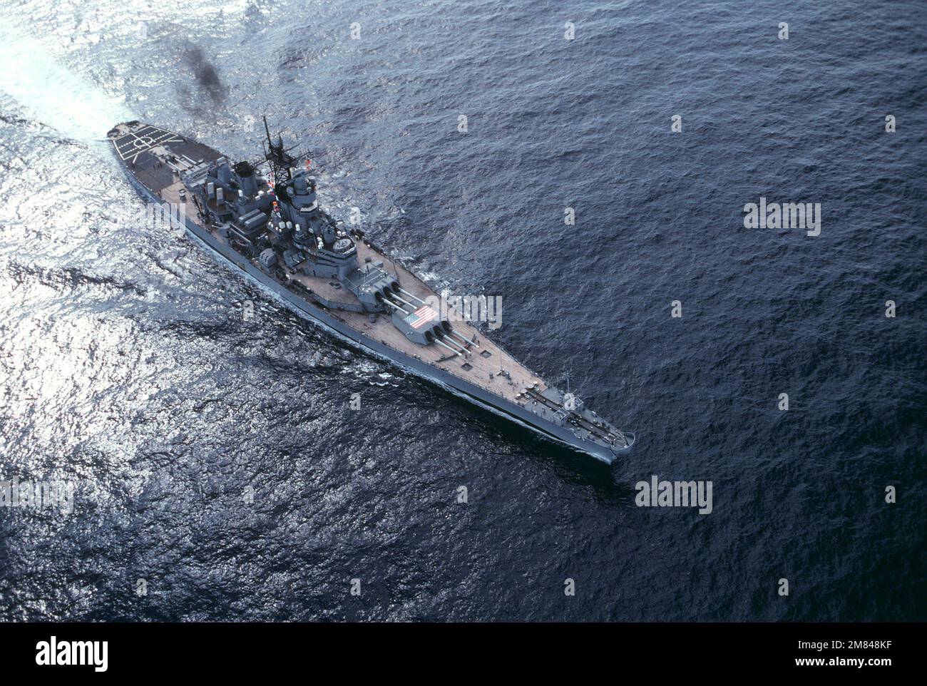 An elevated starboard bow view of the battleship USS IOWA (BB 61) underway off the coast of ...