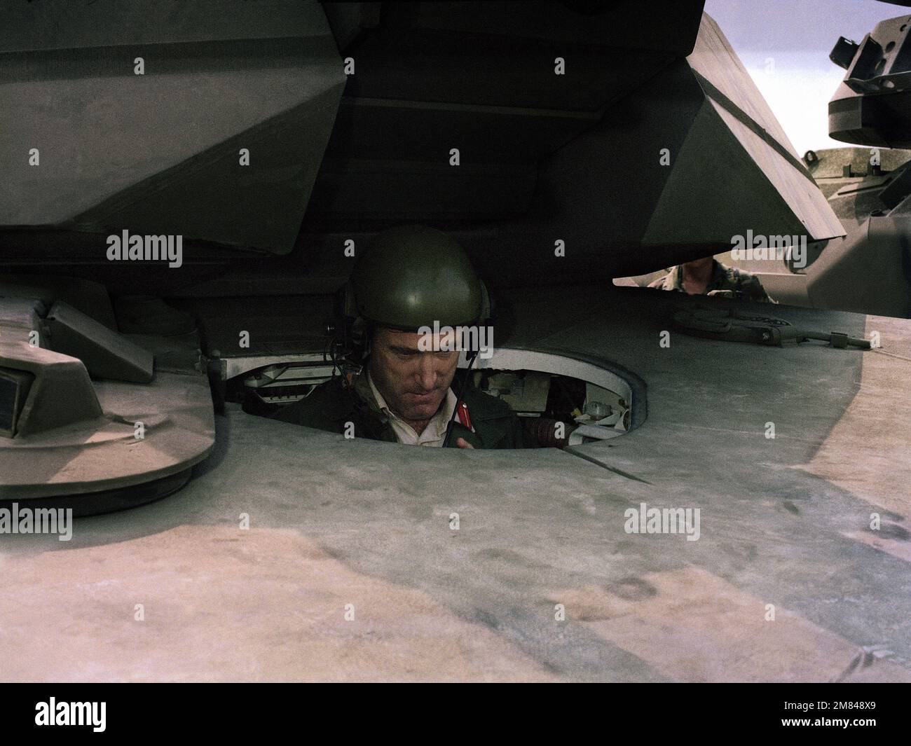Major General Cooper of the British Royal Armoured Corps sits in the ...