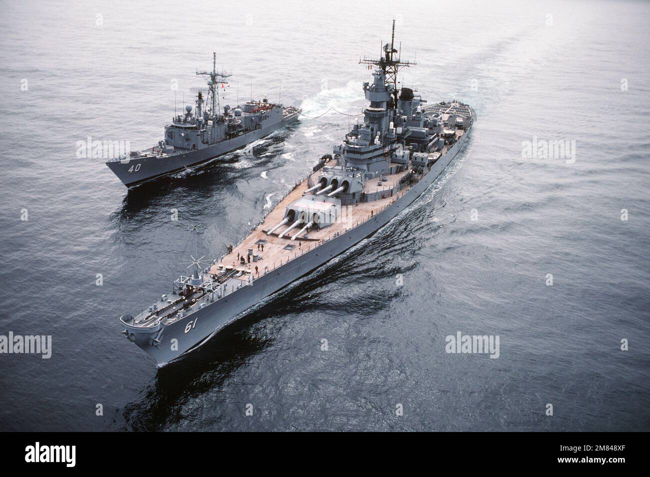 An elevated port bow view of the battleship USS IOWA (BB 61) as it refuels the guided missile ...