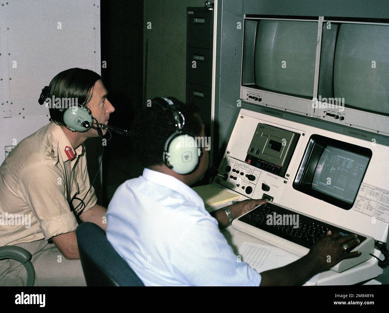 Major General Cooper, left, of the British Royal Armoured Corps views a ...