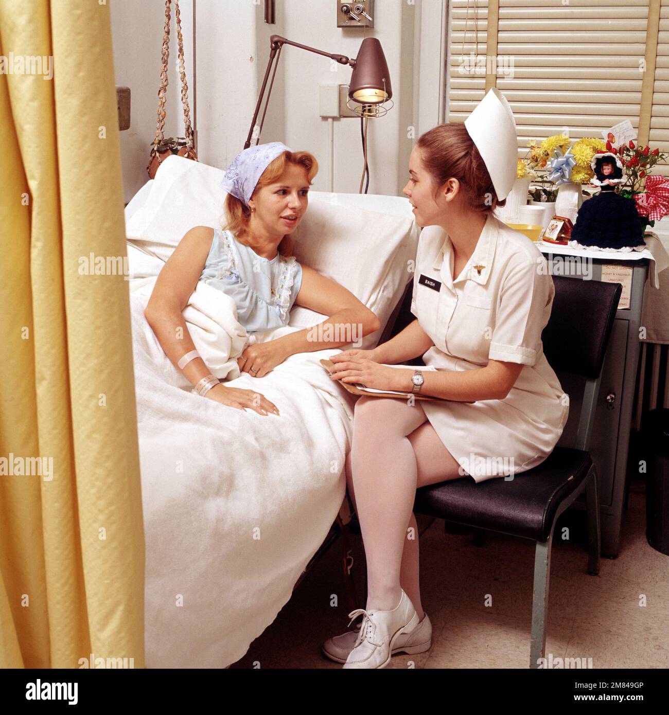 A U.S. Army nurse talks with a patient. Country: Unknown Stock Photo ...