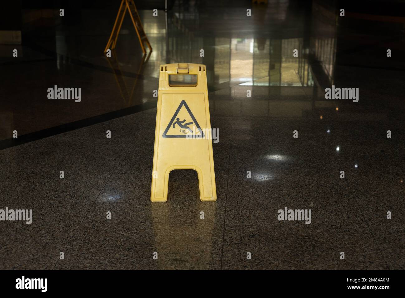 Sign showing warning of caution wet floor Stock Photo - Alamy