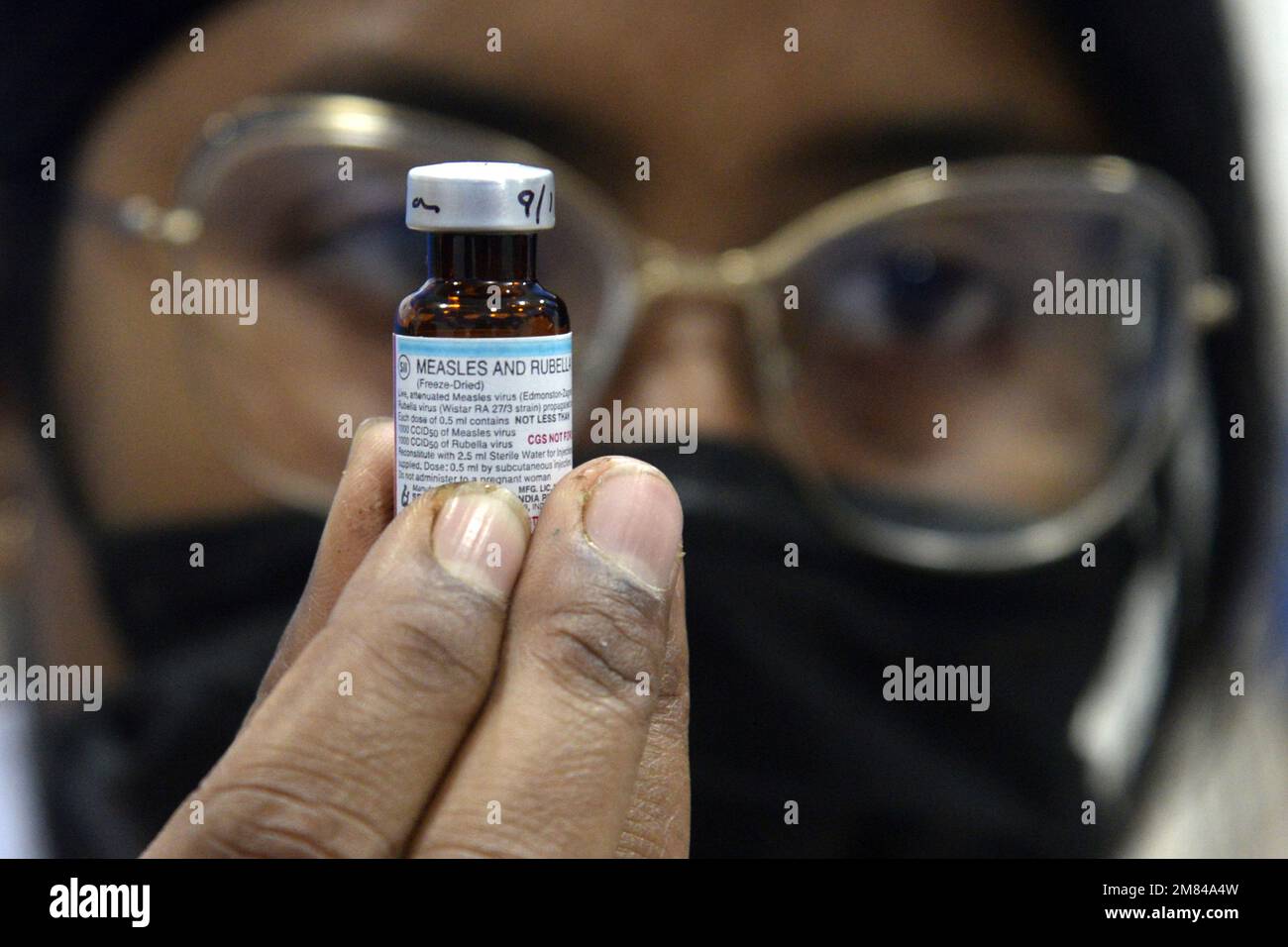 Non Exclusive: Heath worker holds vial of Measle or Rubella or MR ...
