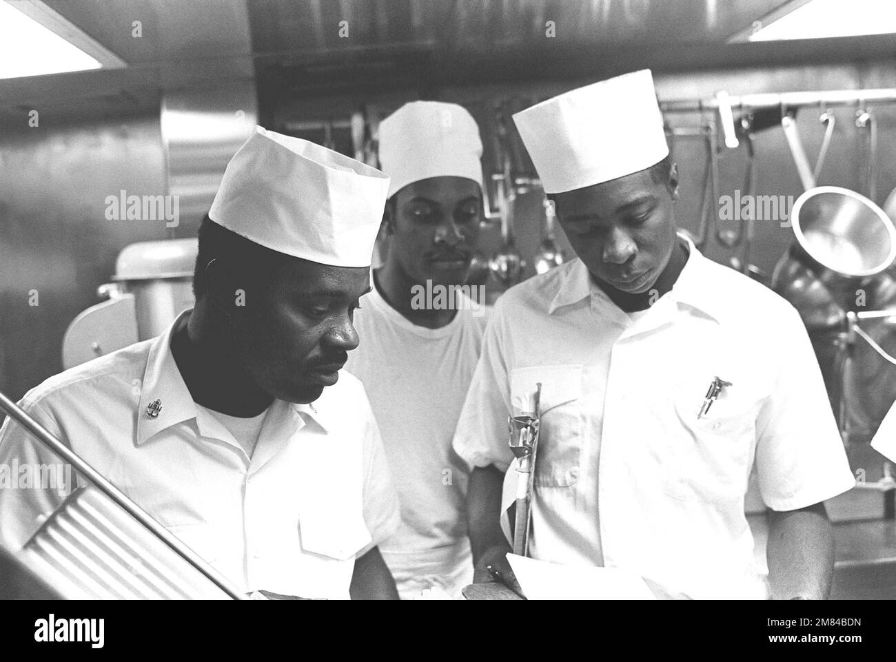 Cooks prepare a meal aboard the guided missile frigate USS HALYBURTON ...