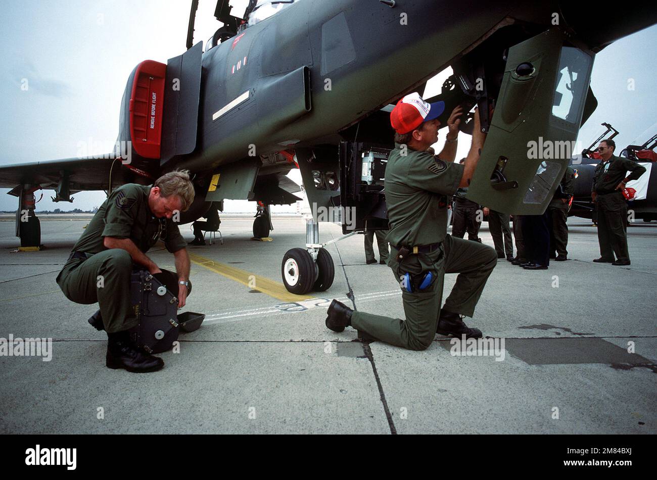 Two U.S. Air Force technicians unload film from an RF-4C Phantom TT ...