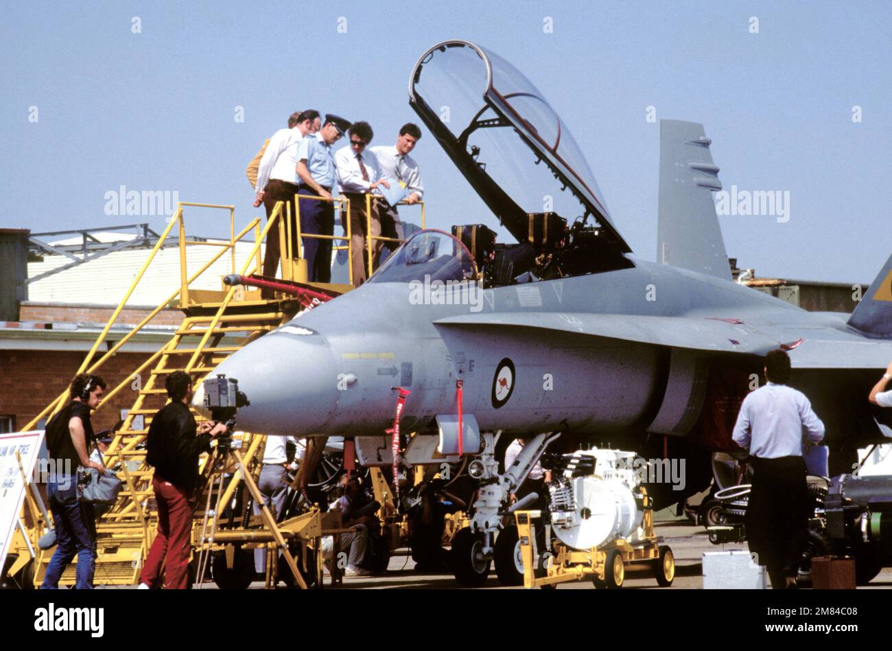 Members of the Australian media inspect an F/A-18 Hornet aircraft on ...