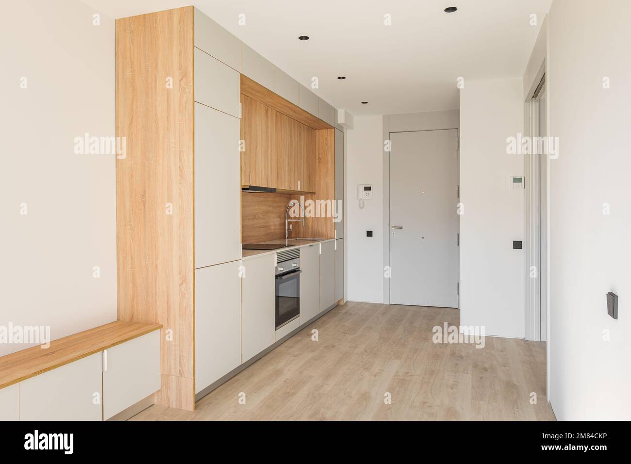 Simple small modular kitchen area along the wall in studio apartment ...