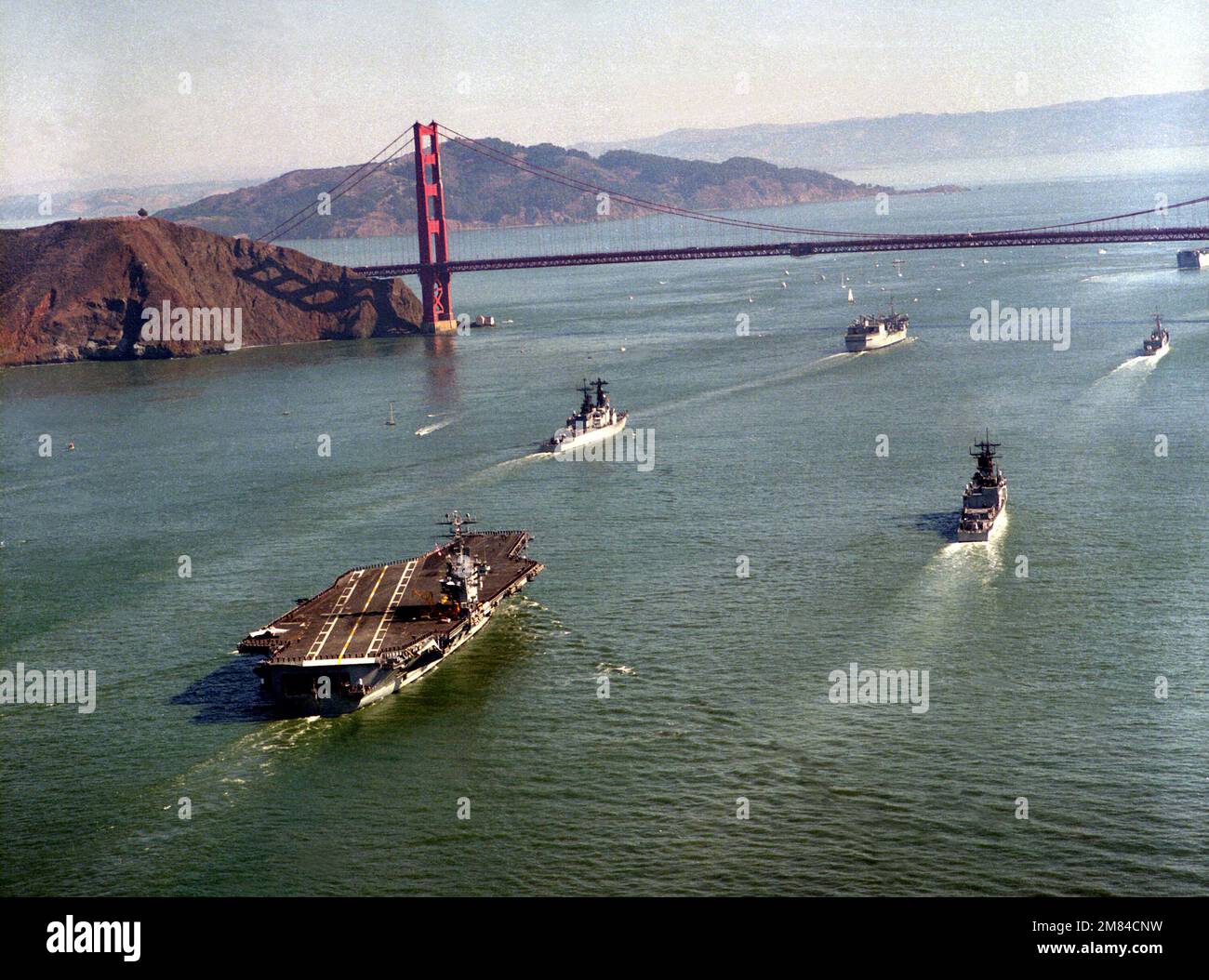 A group of escort ships precede the nuclear-powered aircraft carrier ...