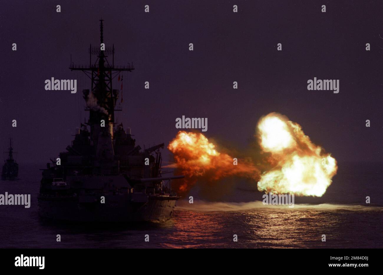 A stern view of the battleship USS IOWA (BB-61) conducting a gunnery ...