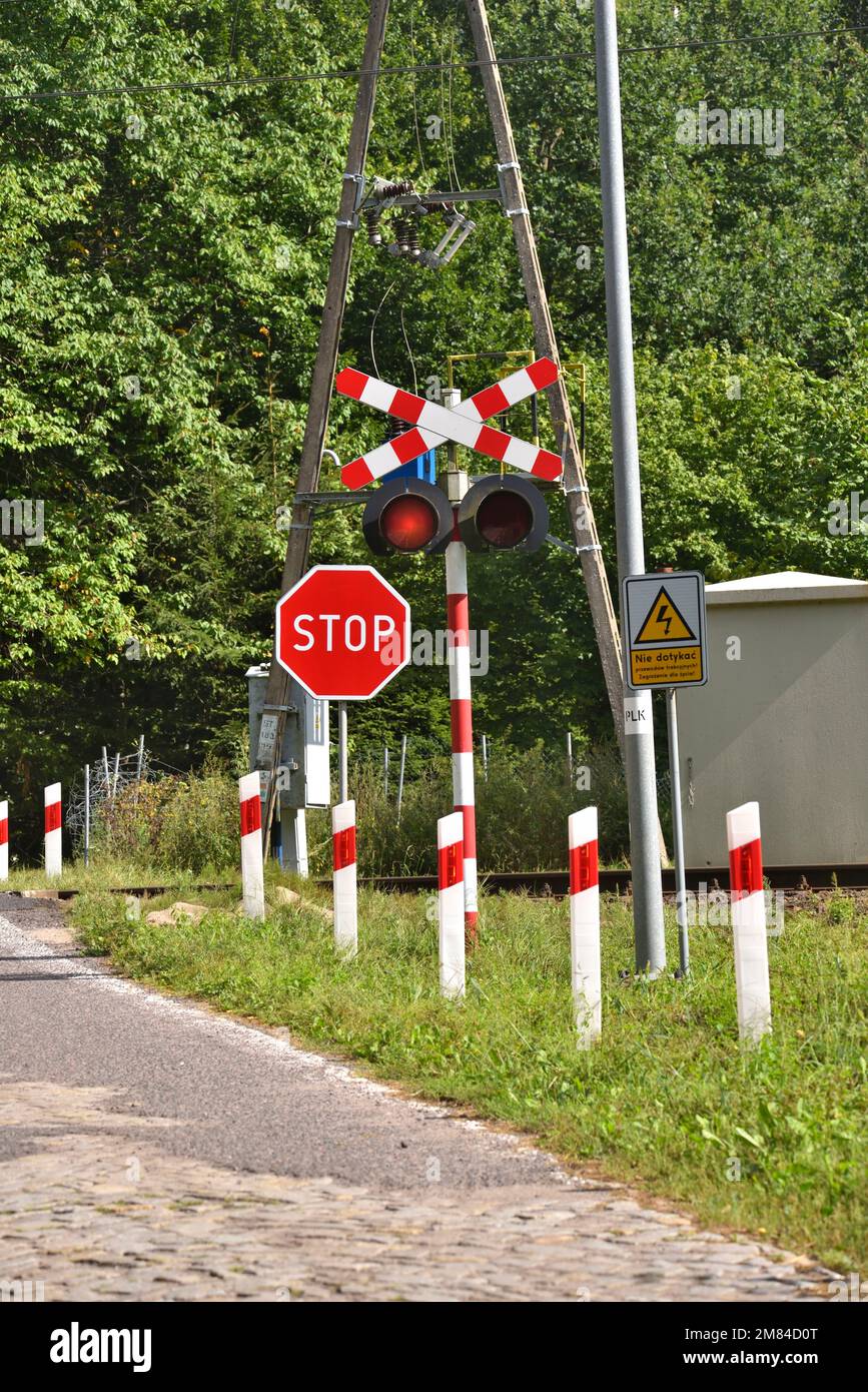 railway crossing on a forest road, the sign says not to touch the ...