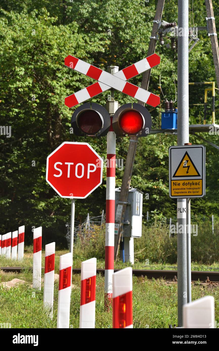 railway crossing on a forest road, the sign says not to touch the ...