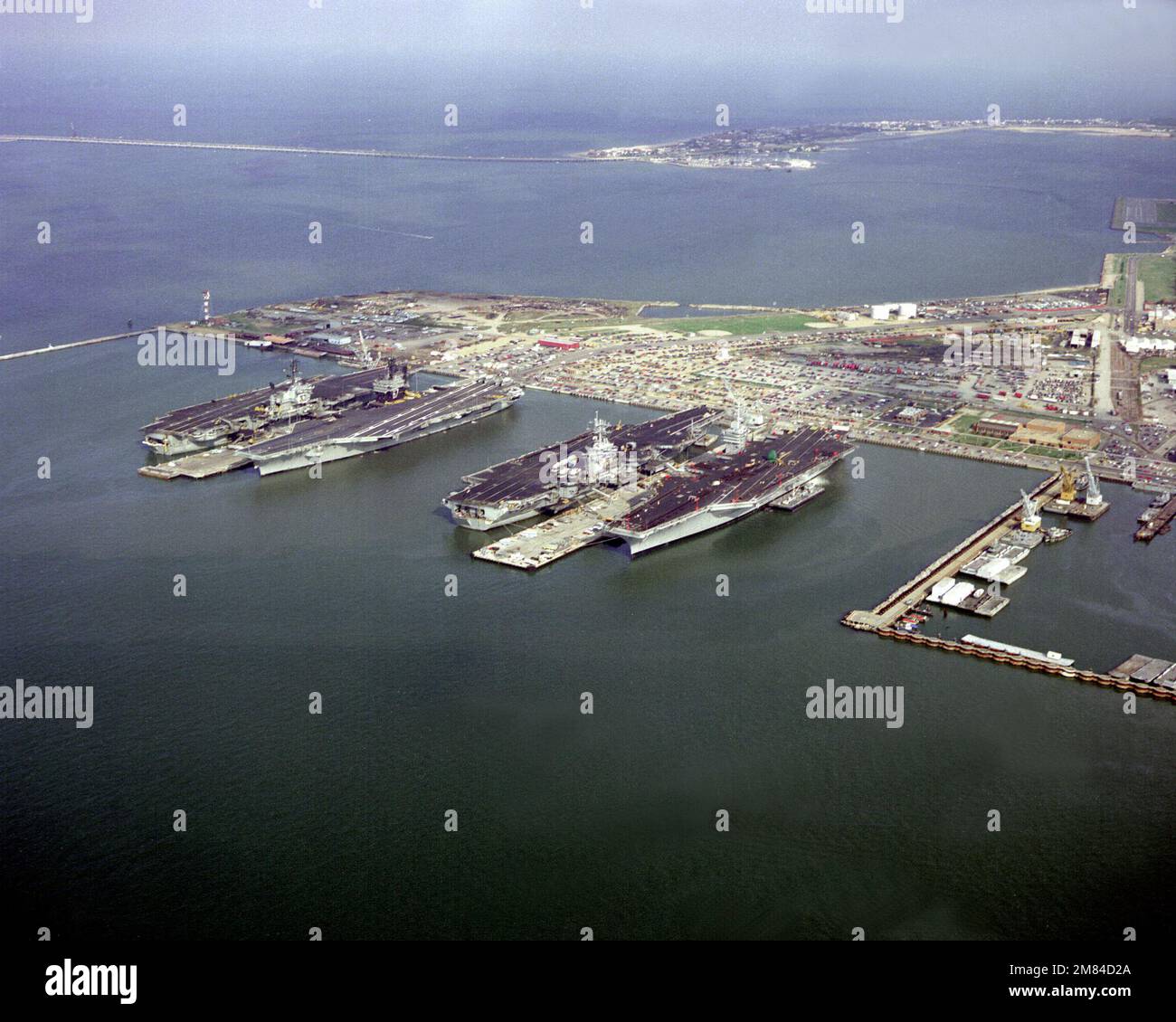 An elevated view, left to right, of the aircraft carriers USS AMERICA ...