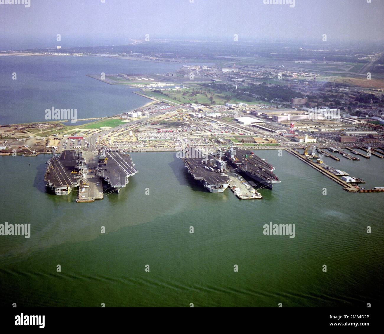 An elevated view, left to right, of the aircraft carriers USS AMERICA ...