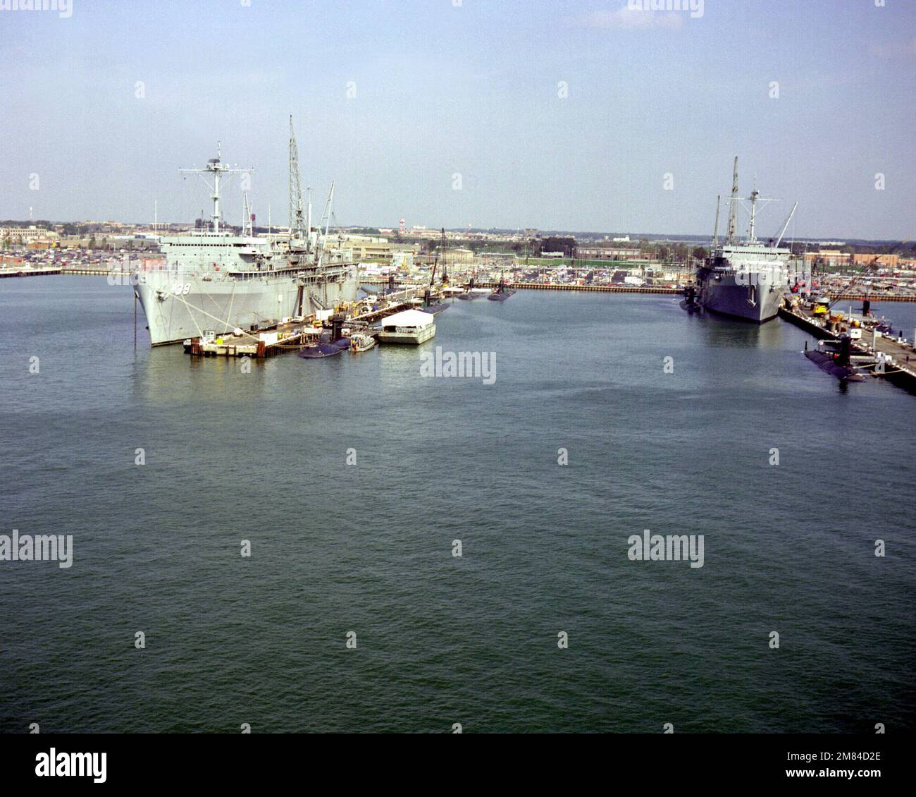 Several nuclear-powered attack submarines are moored near the submarine ...