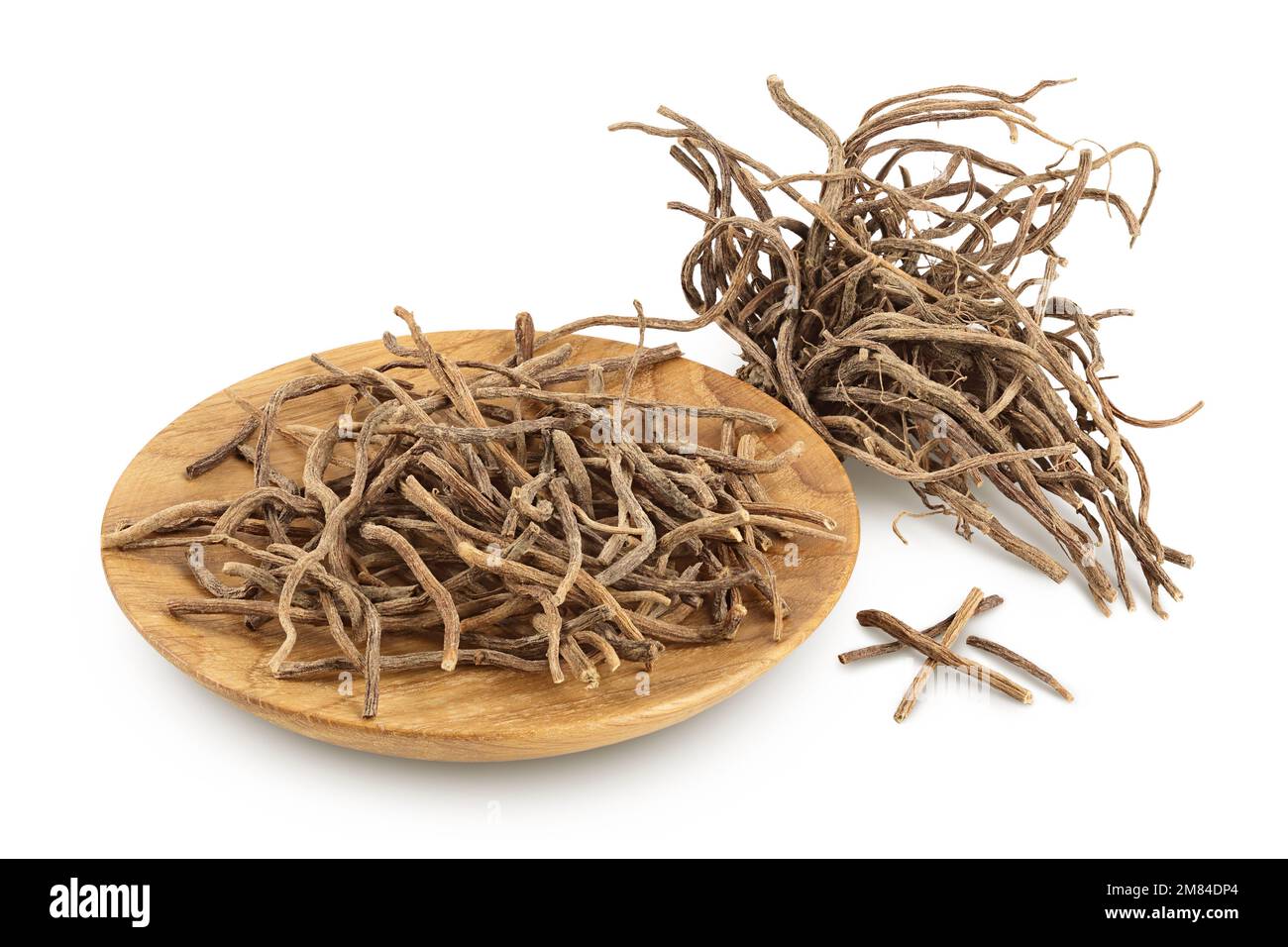 Dried Valerian root in wooden bowl isolated on white background ...