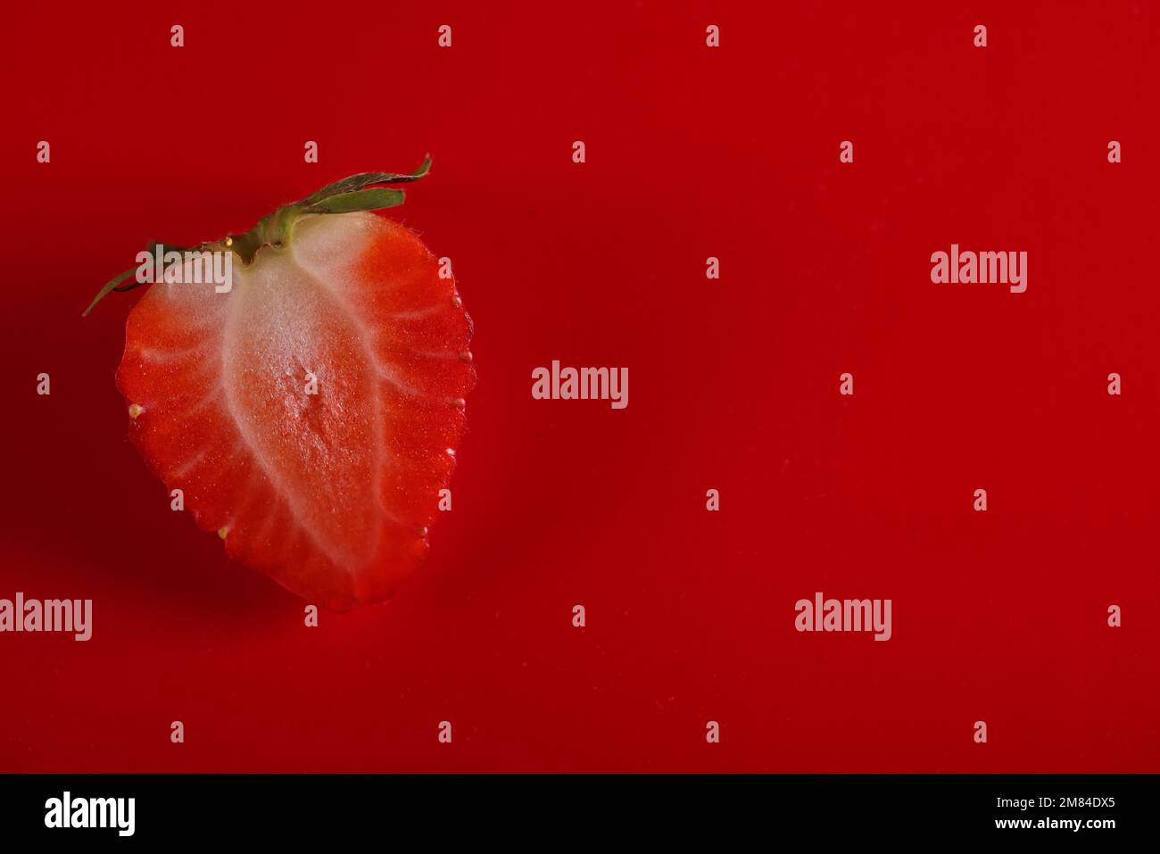 berry strawberry on a red background symbol of love Stock Photo - Alamy