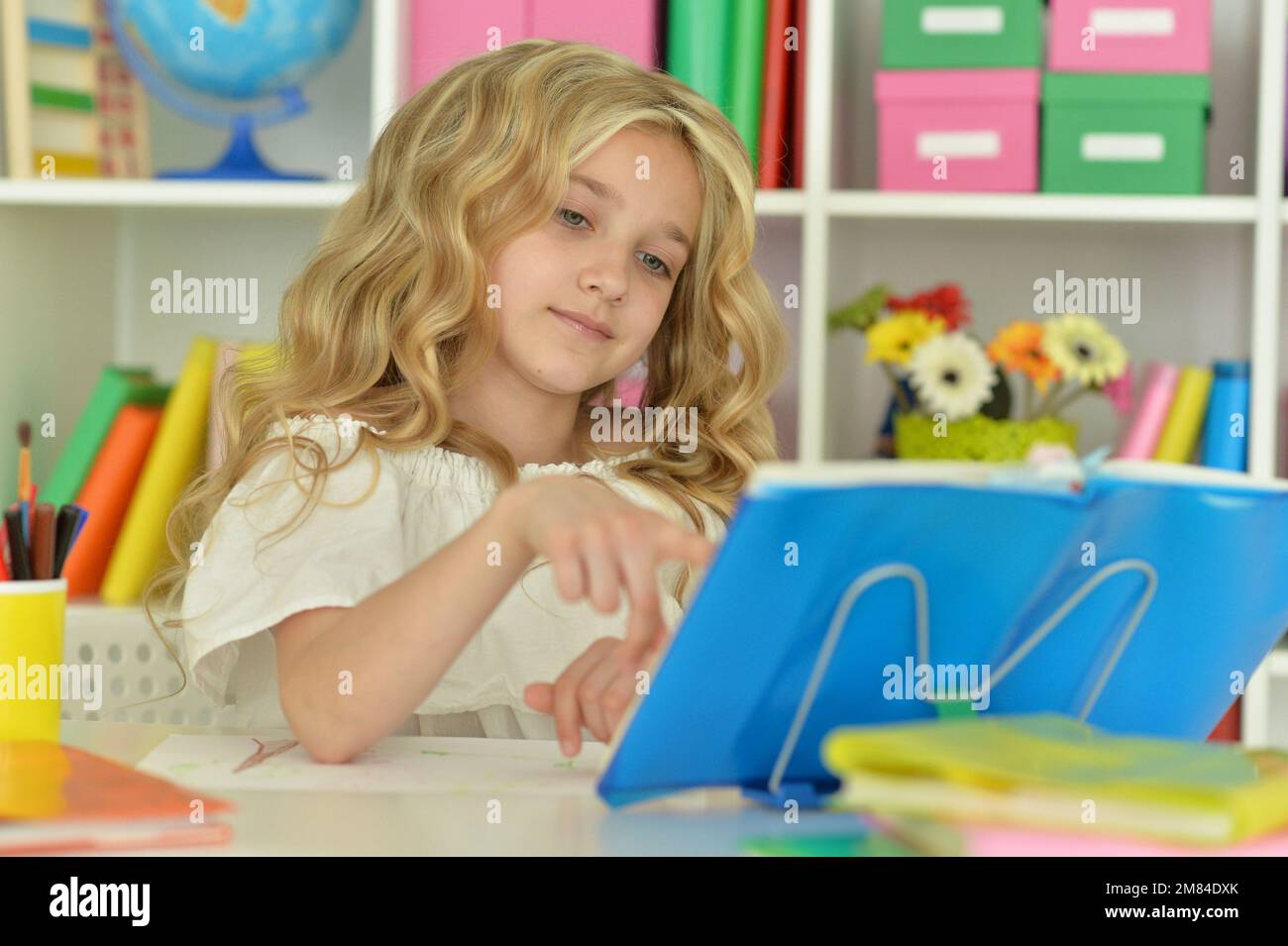 little girl studying at home at the table Stock Photo - Alamy