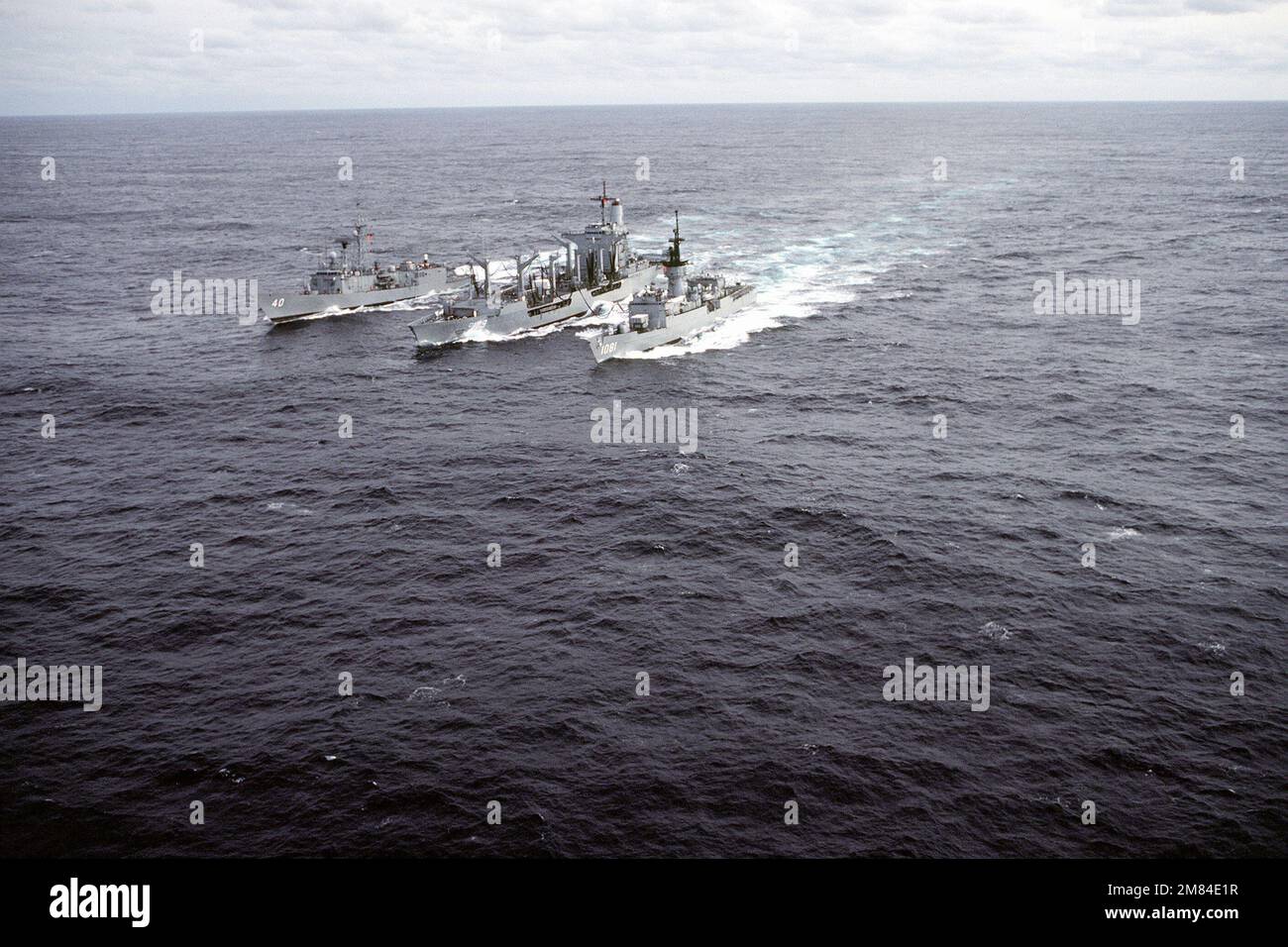 The fleet oiler USS MERRIMACK (AO-179) refuels the guided missile ...