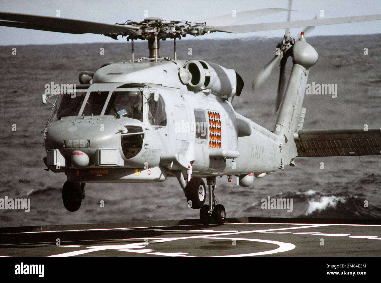 A SH-60B Seahawk helicopter lands on the deck of a ship. Country ...