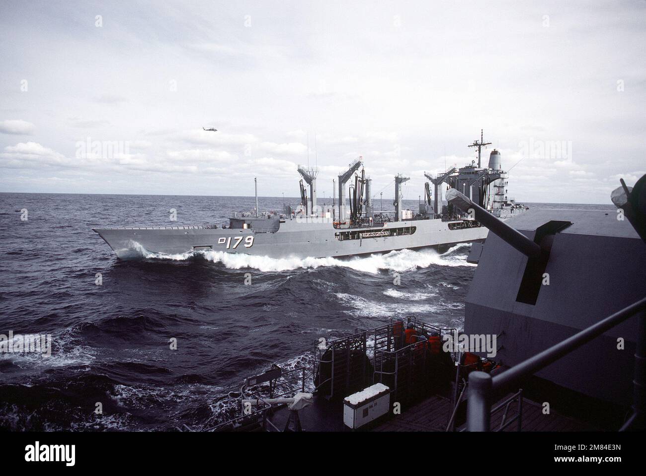 The fleet oiler USS MERRIMACK (AO-179) refuels the battleship USS IOWA ...