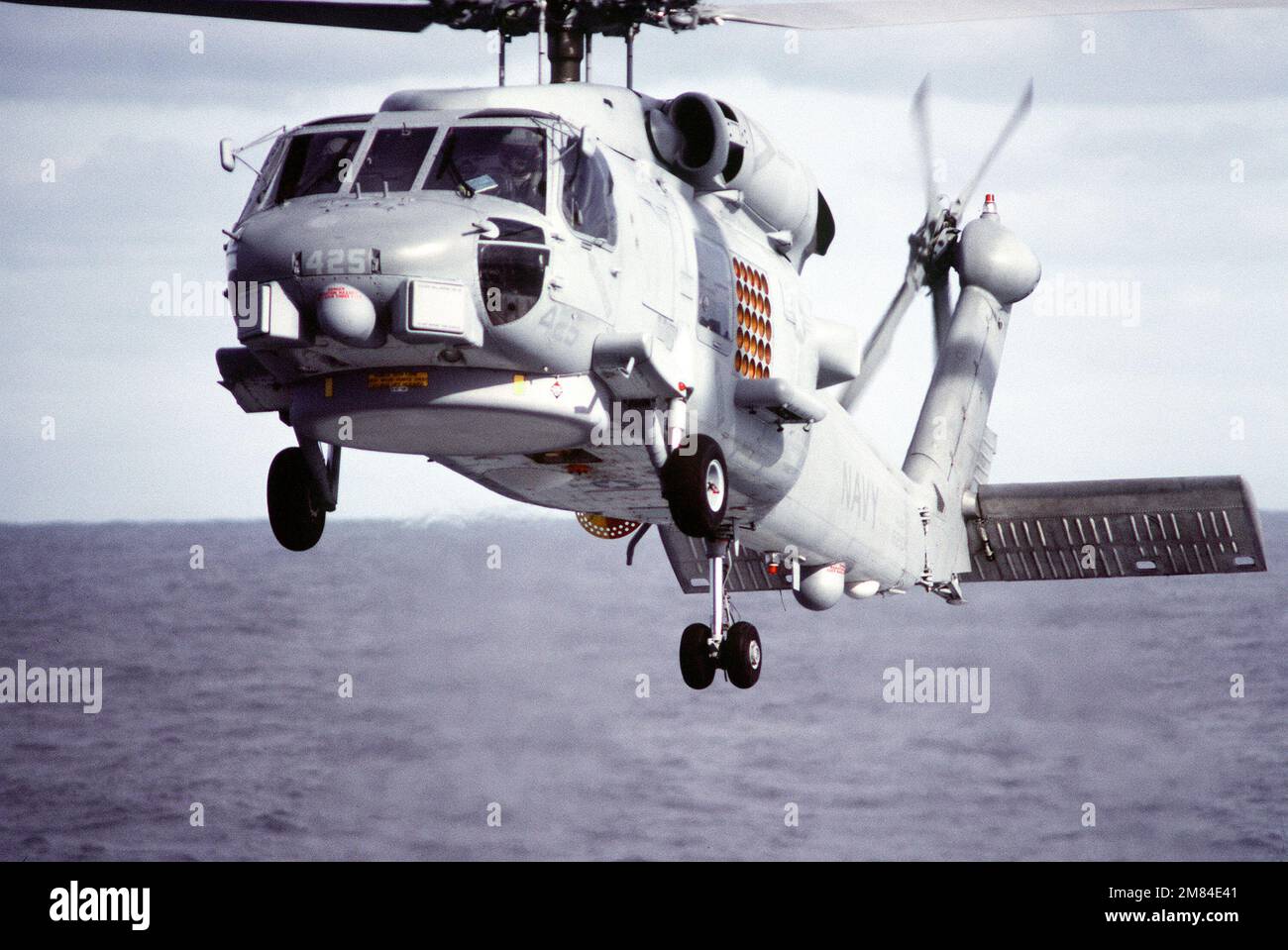 A SH-60B Seahawk helicopter approaches for a landing on the stern of a ...