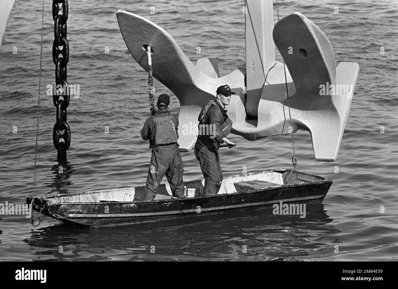 Crew members paint the starboard anchor of the battleship USS IOWA (BB ...