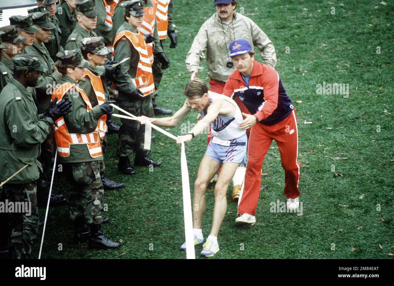 A runner is assisted in cooling off during the Tenth Annual Marine ...