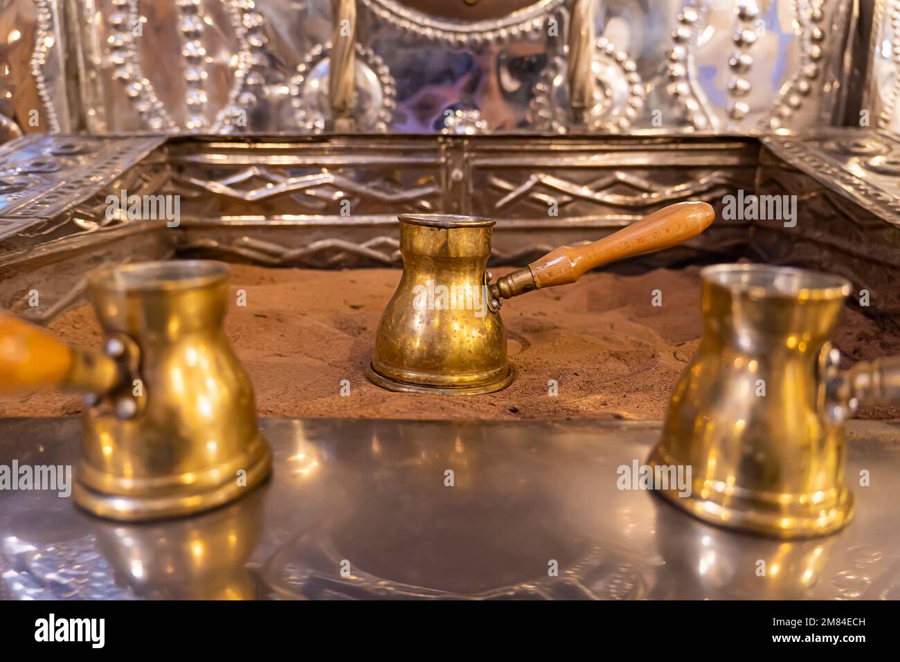 coffee maker in hot sand. Traditional oriental method of making coffee ...