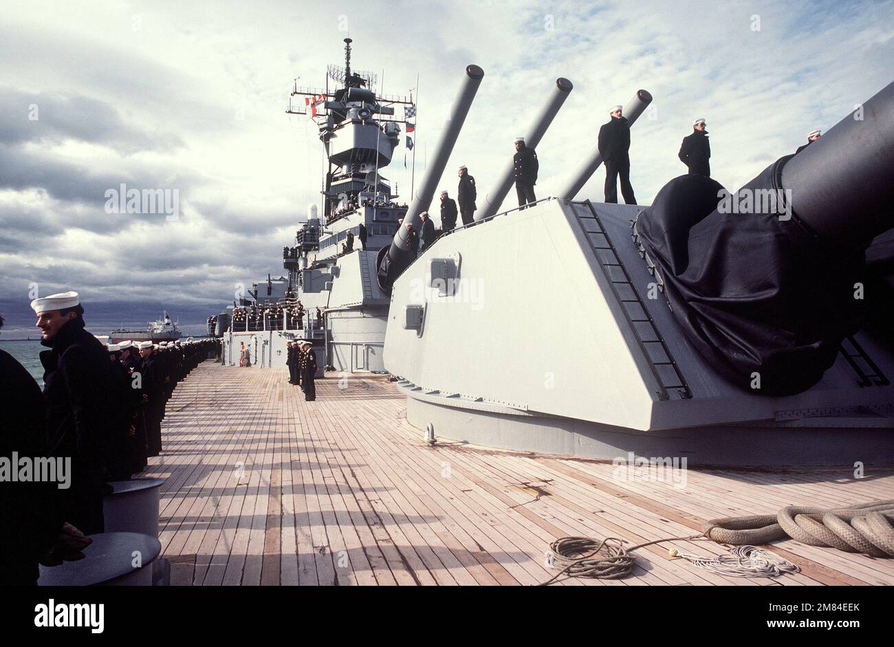 Crewmen aboard the battleship USS IOWA (BB-61) man the rails as the ...