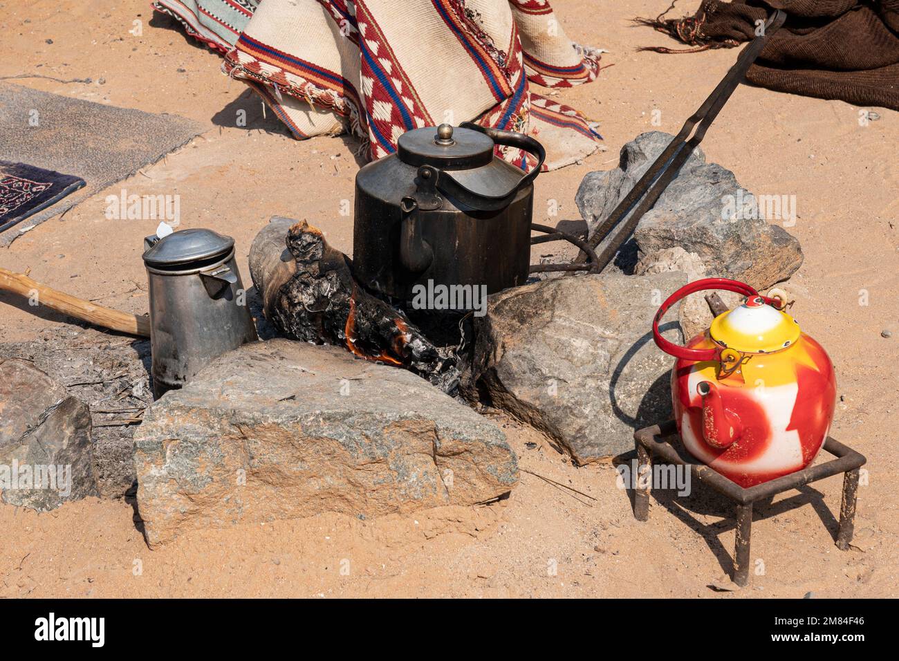 campfire with an iron kettle in the desert. making tea or coffee during ...