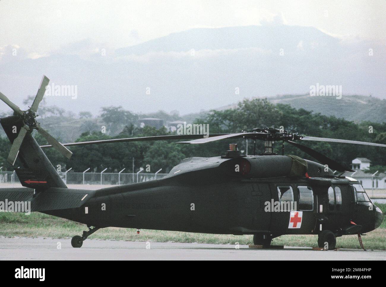 A U.S. Army UH-60A Blackhawk helicopter is parked on the flight line ...