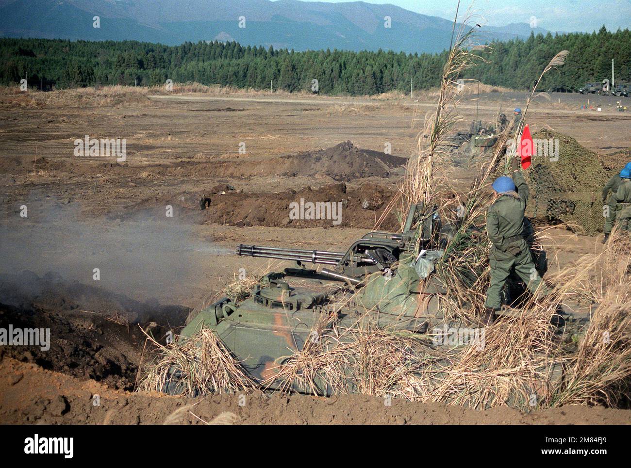 A camouflaged M-163 20mm Vulcan self-propelled anti-aircraft gun is ...