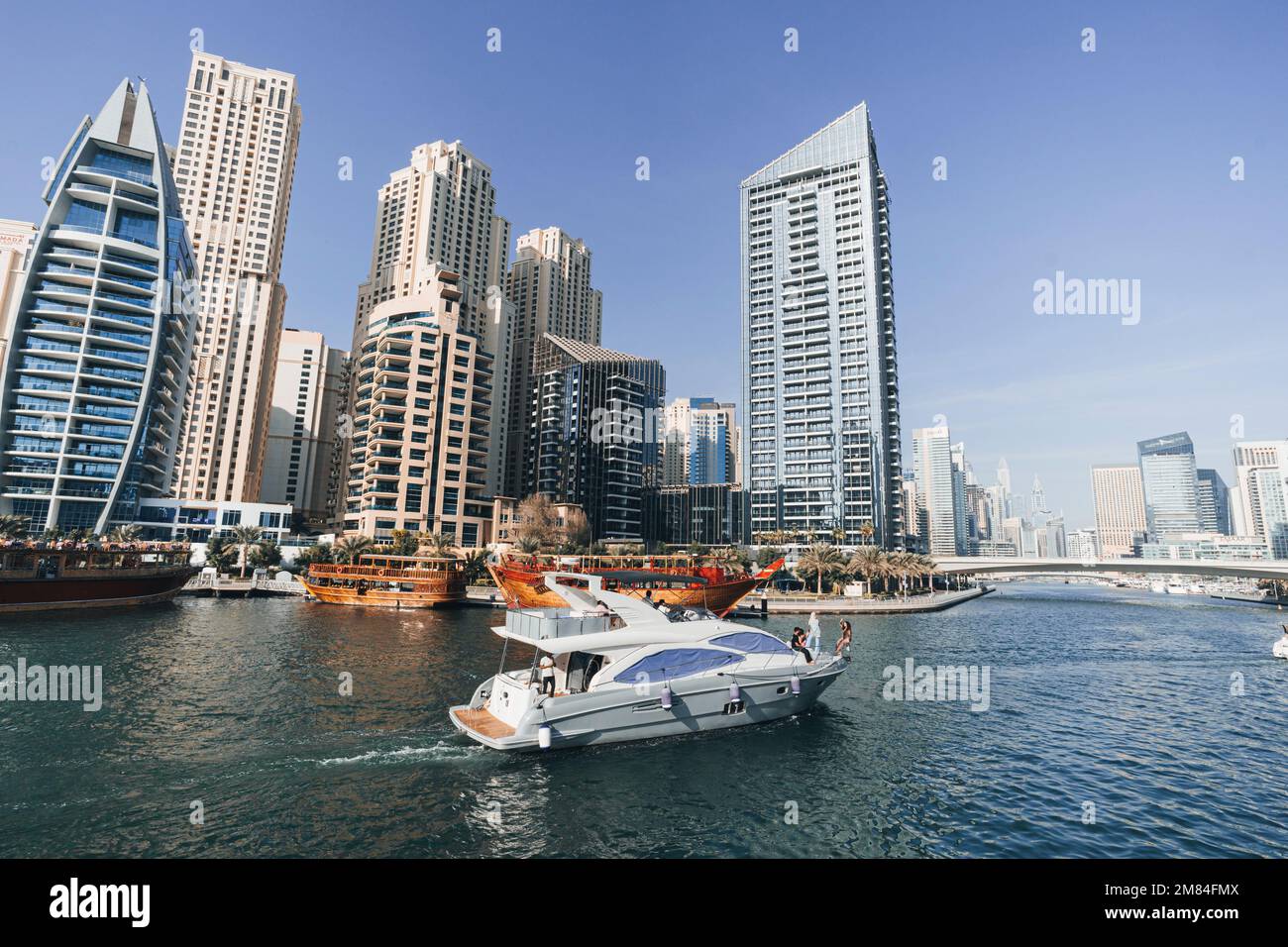 Dubai Marina in a summer day, United Arab Emirates. luxury yachts take ...