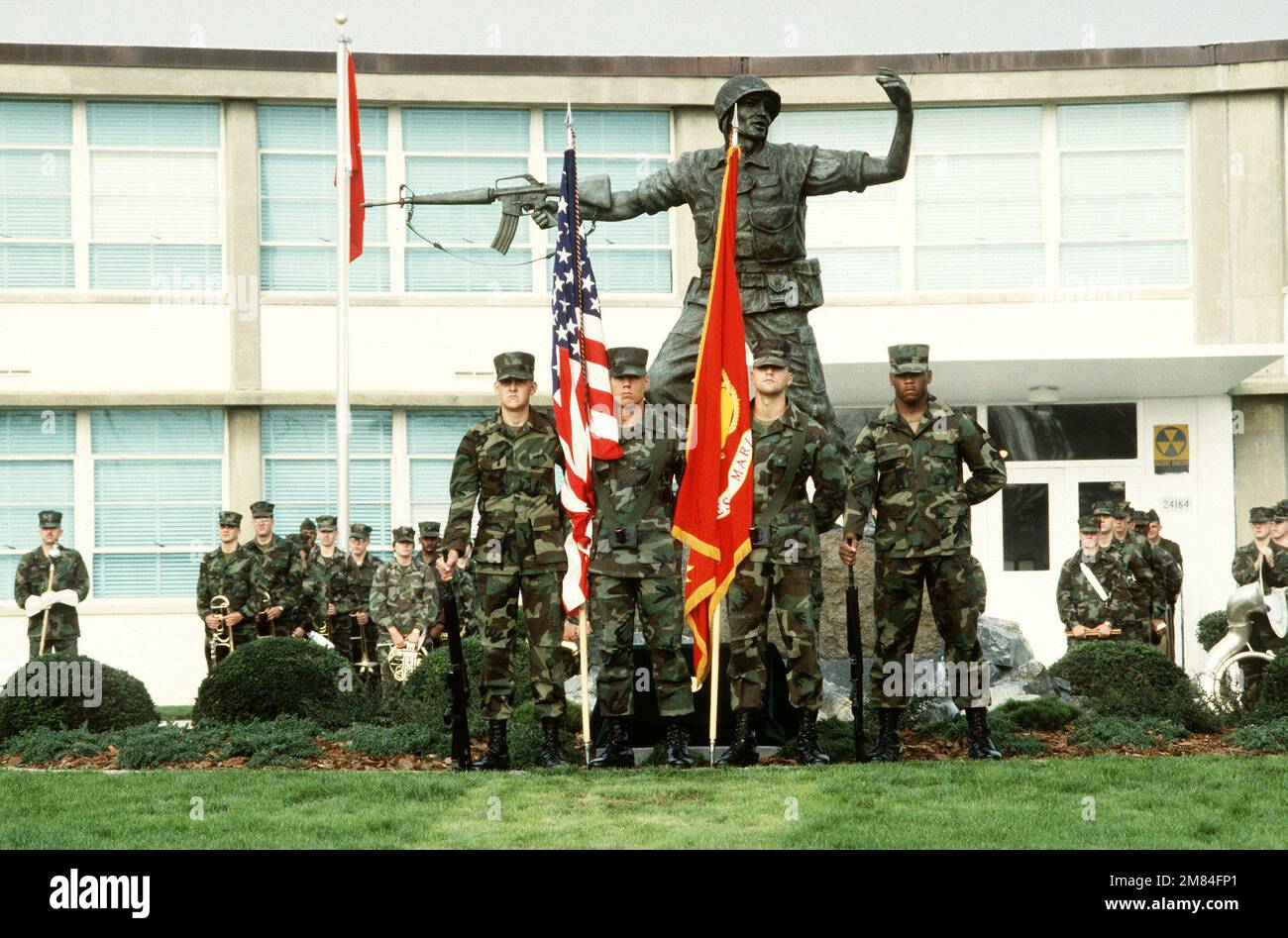 A U.S. Marine Corps color guard presents the colors as other Marines ...