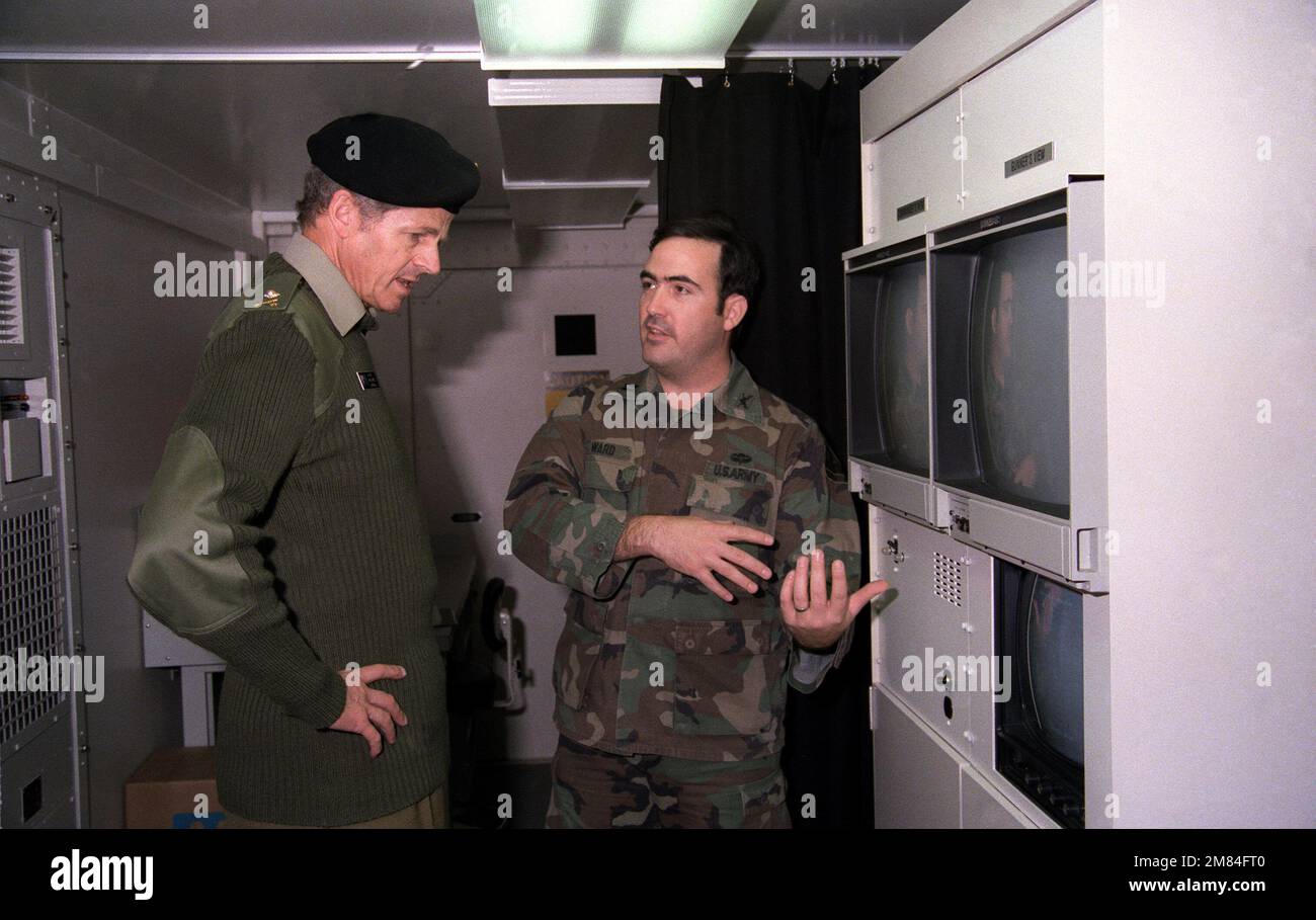 A US Army captain explains the functions of a training device to ...