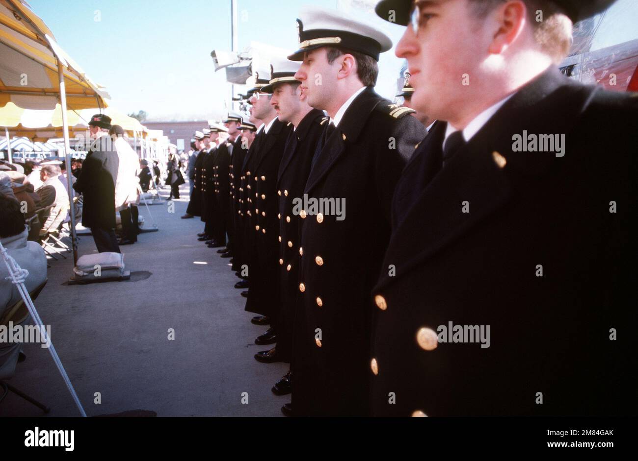 Naval officers stand at attention during the commissioning of the ...