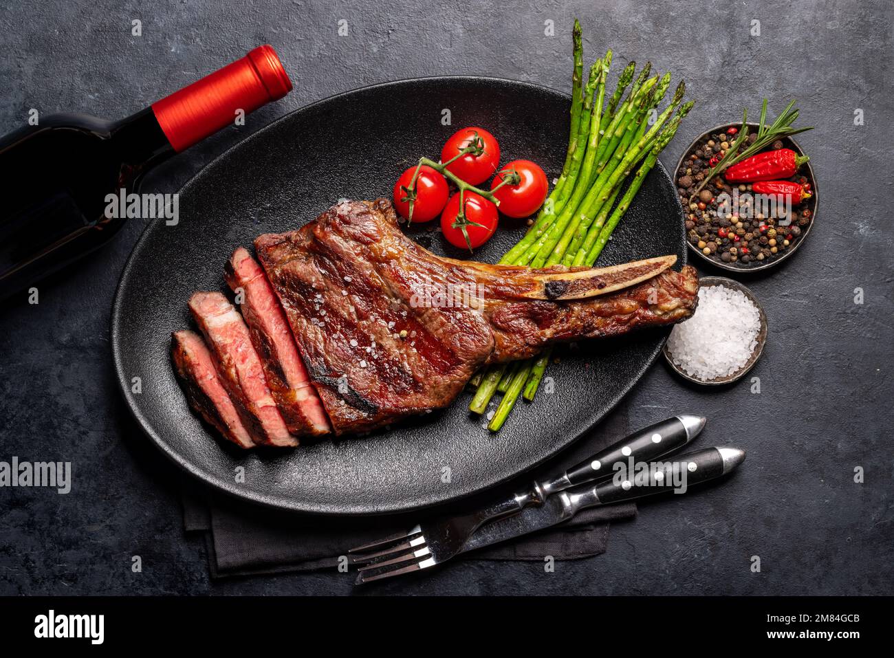 Medium rare grilled Tomahawk beef steak with asparagus. Flat lay Stock ...