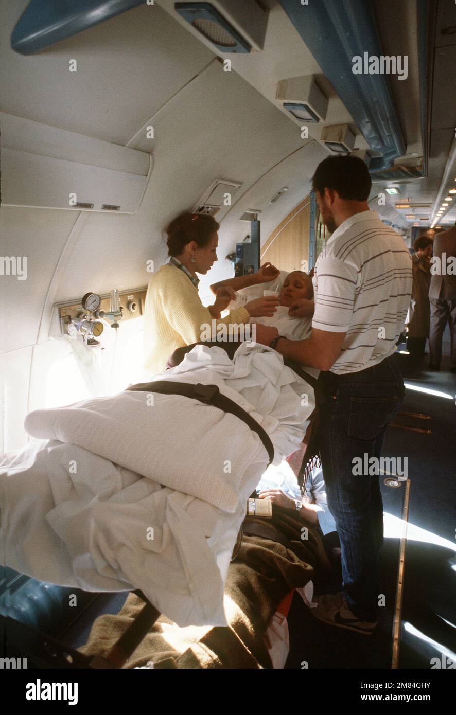 Air Force flight nurse, 1ST LT. Lesa Schwartz, helps Jackie Pfluge, 30 ...