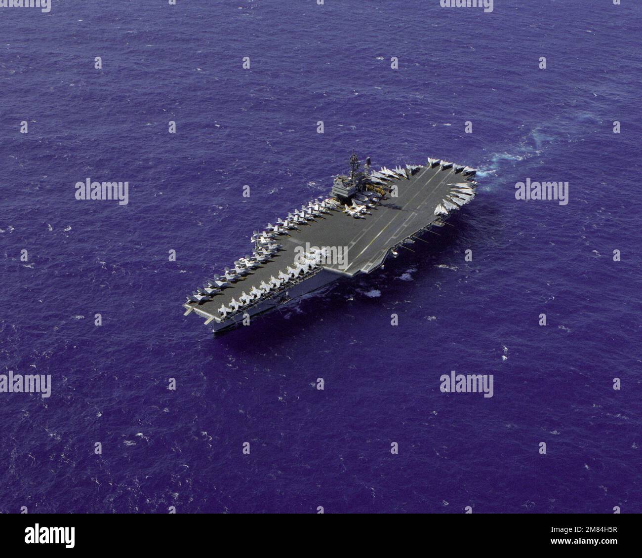 An aerial port bow view of the aircraft carrier USS KITTY HAWK (CV-63 ...