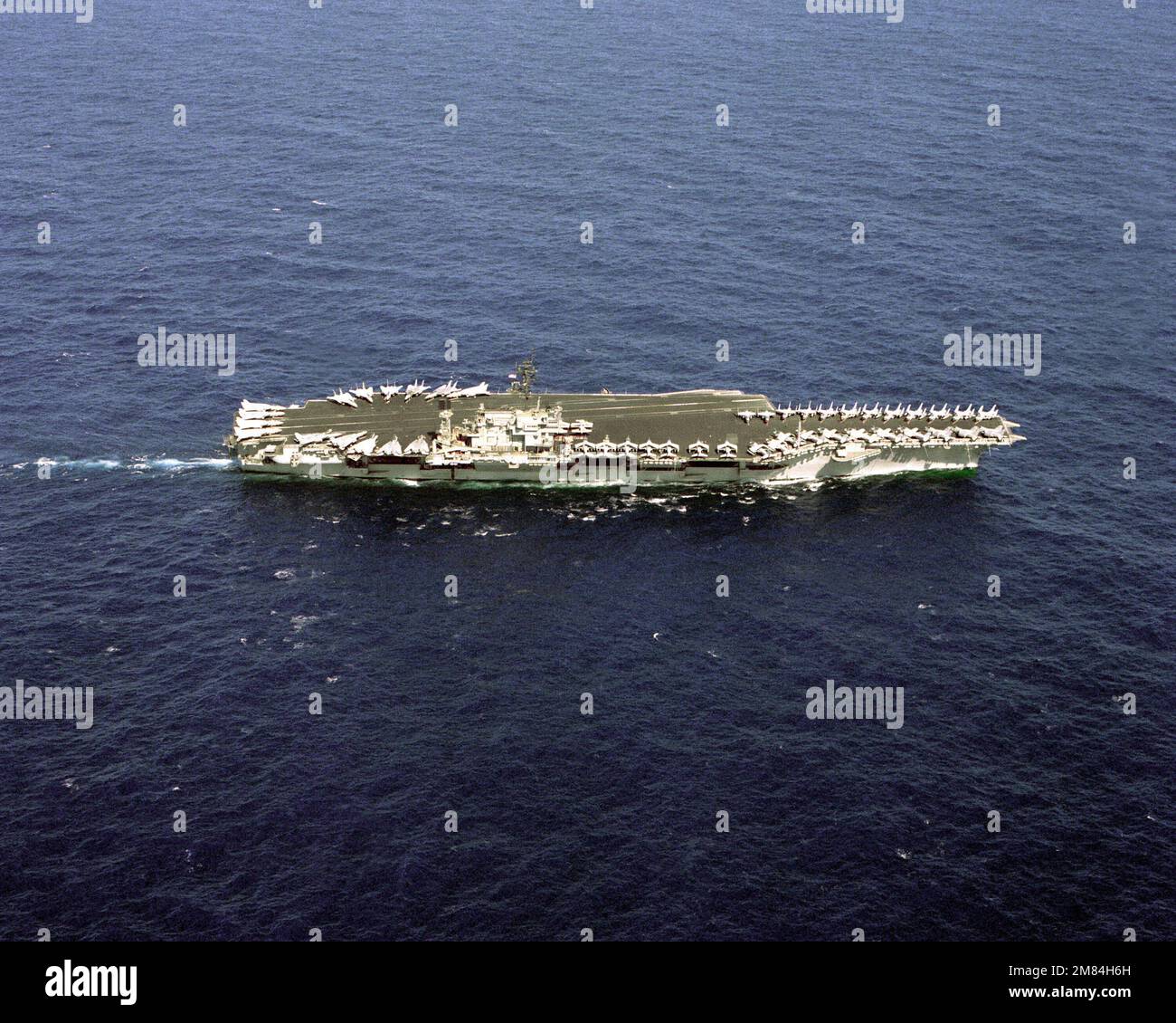 An aerial starboard beam view of the aircraft carrier USS KITTY HAWK ...