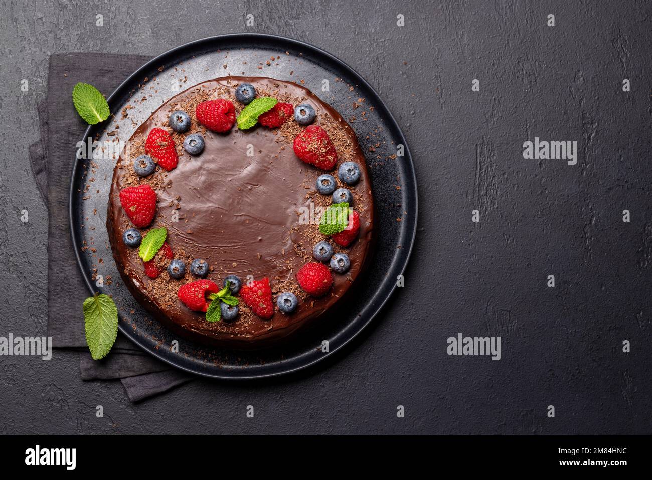 Chocolate cake dessert with fresh berries. Flat lay with copy space ...