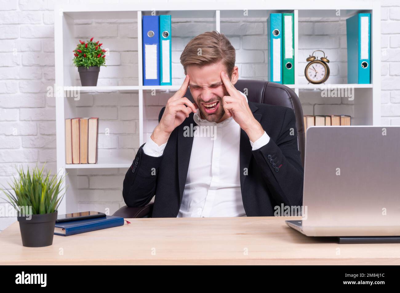 photo of stressed businessman has headache pain. stressed businessman ...