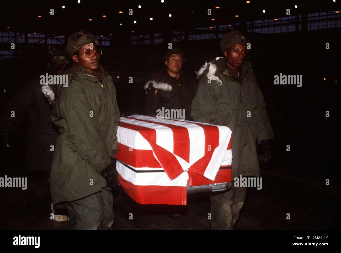 Soldiers carry a casket containing the remains of a member of the 3rd ...