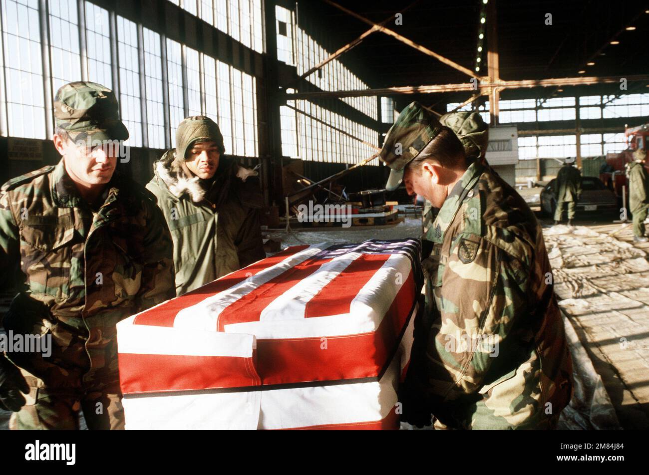 Soldiers carry a casket containing the remains of a member of the 3rd ...