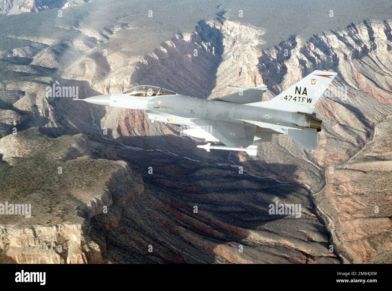 An air-to-air left side view of a 474th Tactical Fighter Wing (474th ...
