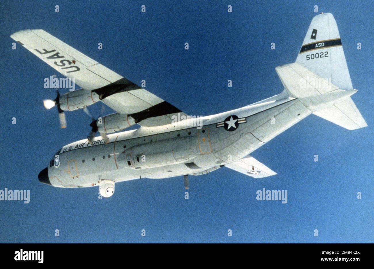 A left underside view of an NC-130A Hercules aircraft in flight with its Airborne Seeker ...