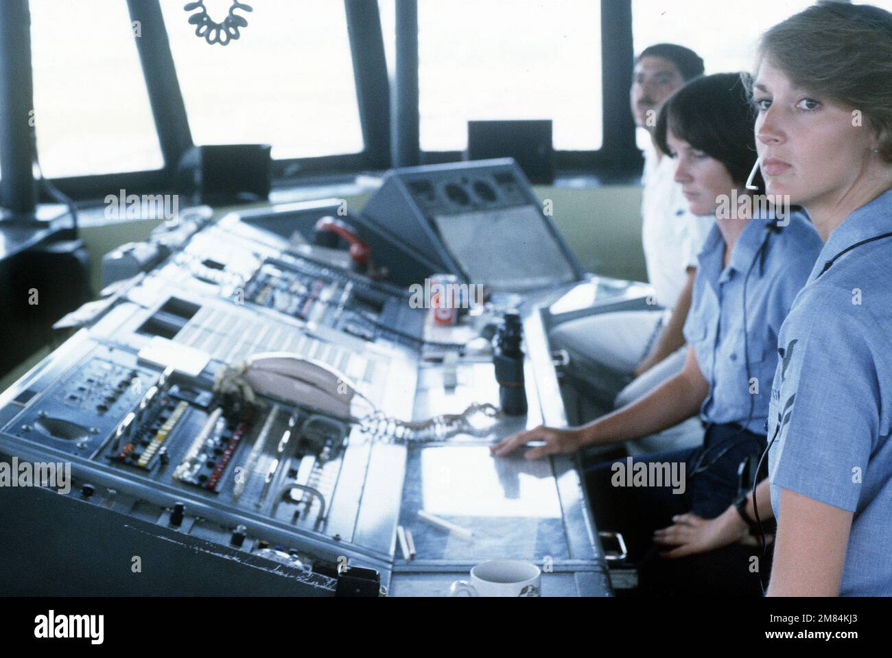 Female petty officers work at their stations in an air traffic control ...