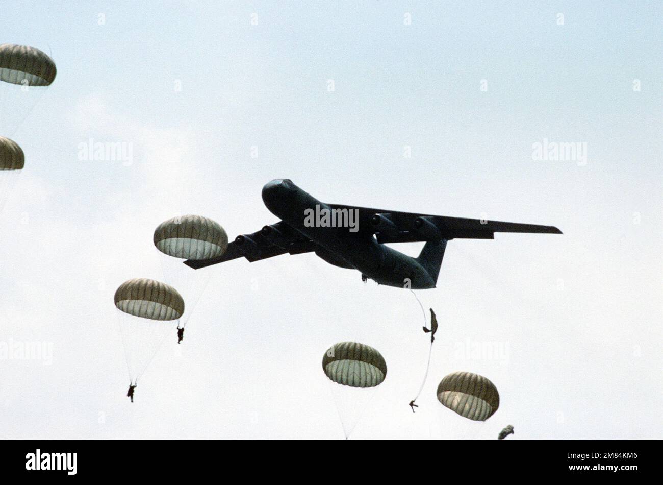 Soldiers of the U.S. Army 82nd Airborne Division parachute from a C ...