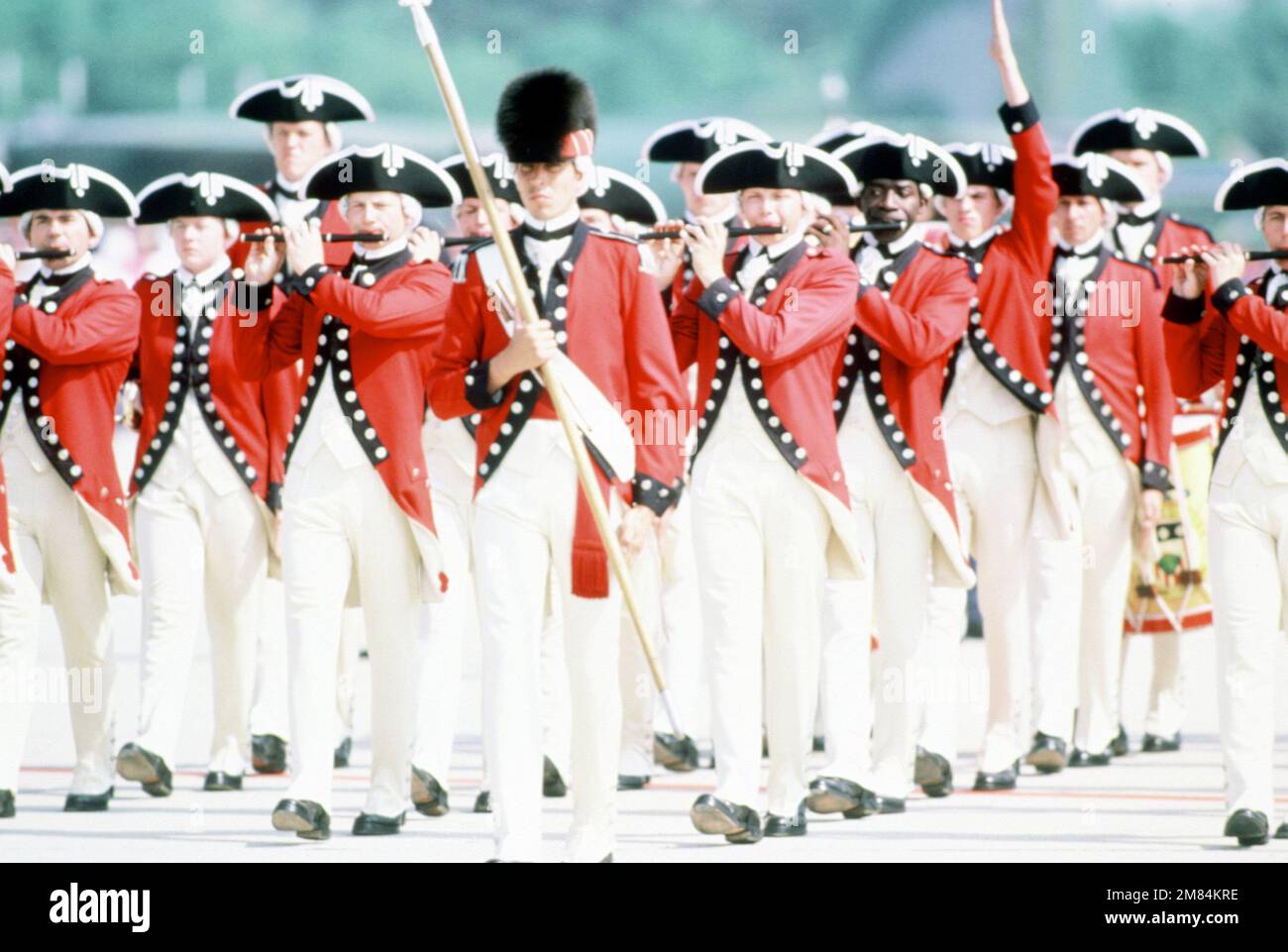 Members of a marching band dressed in colonial uniforms perform during ...